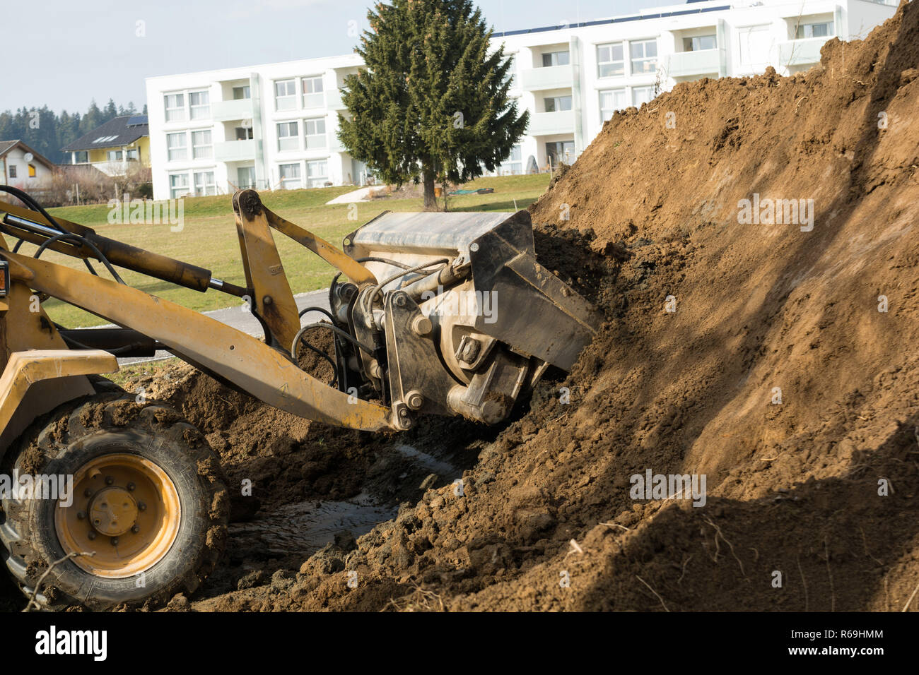 Wheel Loaders Scooping Soil From Construction Site Stock Photo - Alamy