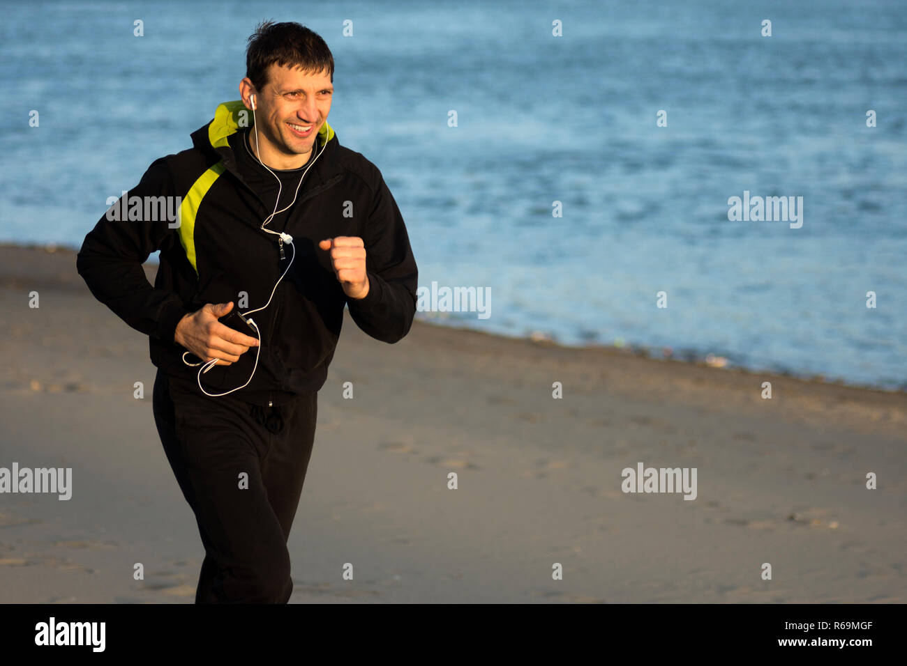 running man with earphones Stock Photo - Alamy