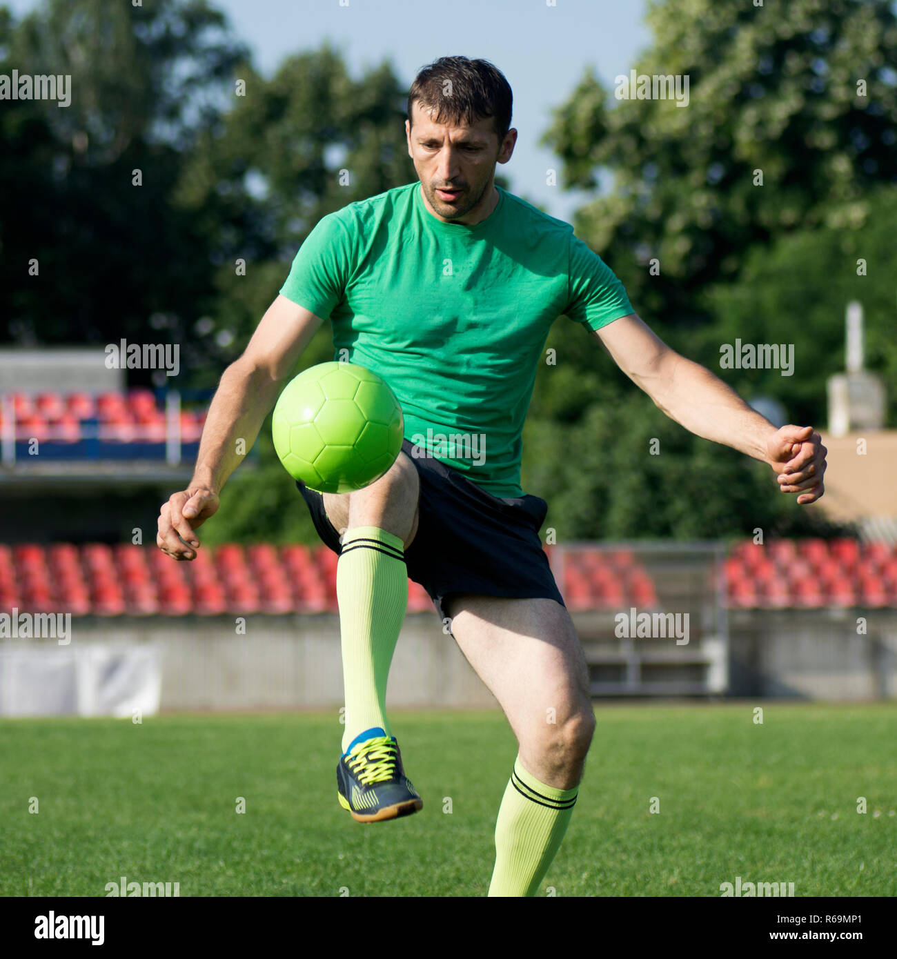 playing soccer player Stock Photo - Alamy