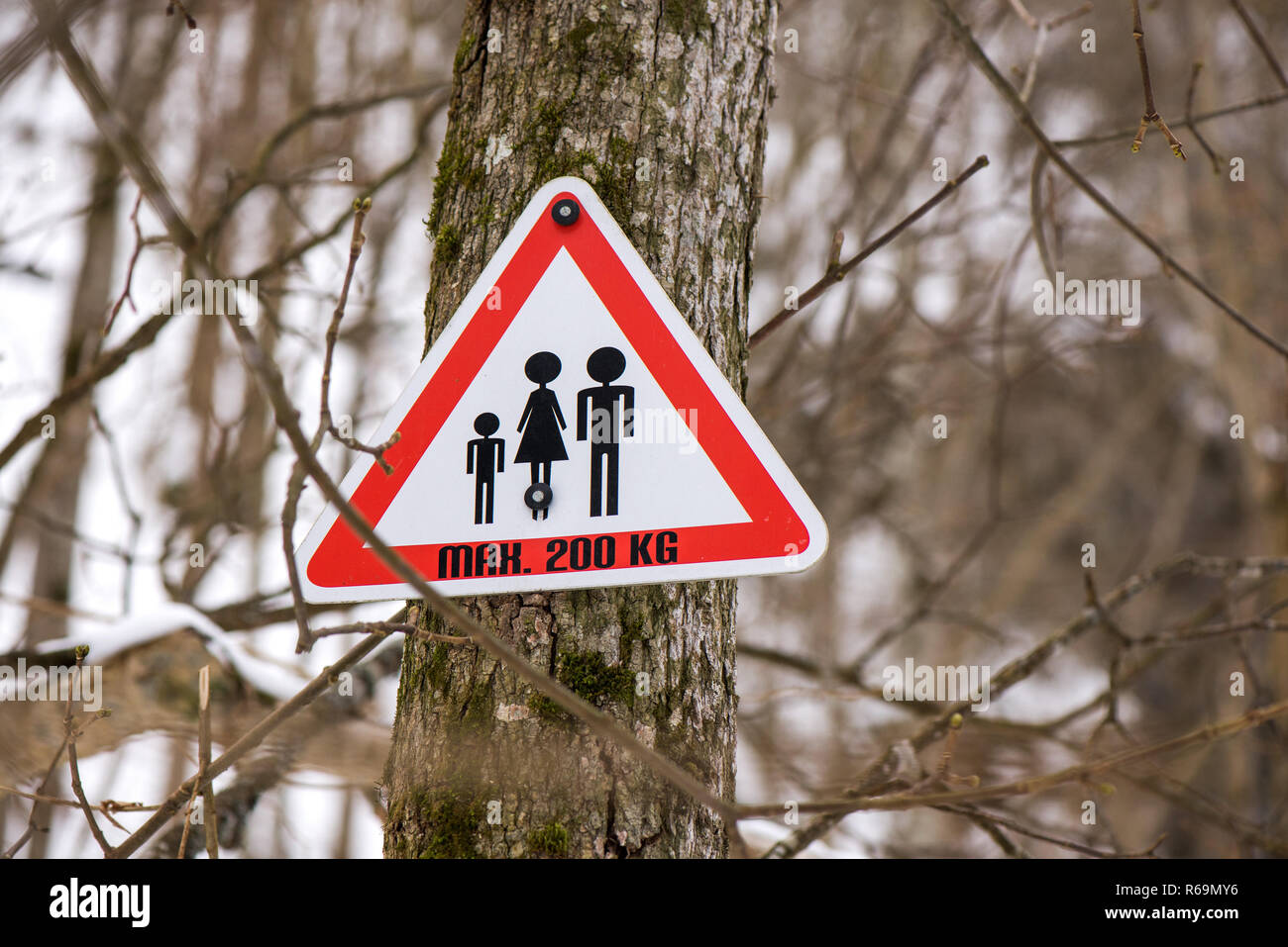 Warning sign of maximum weight 200 kg allowed on wooden bridge at ...