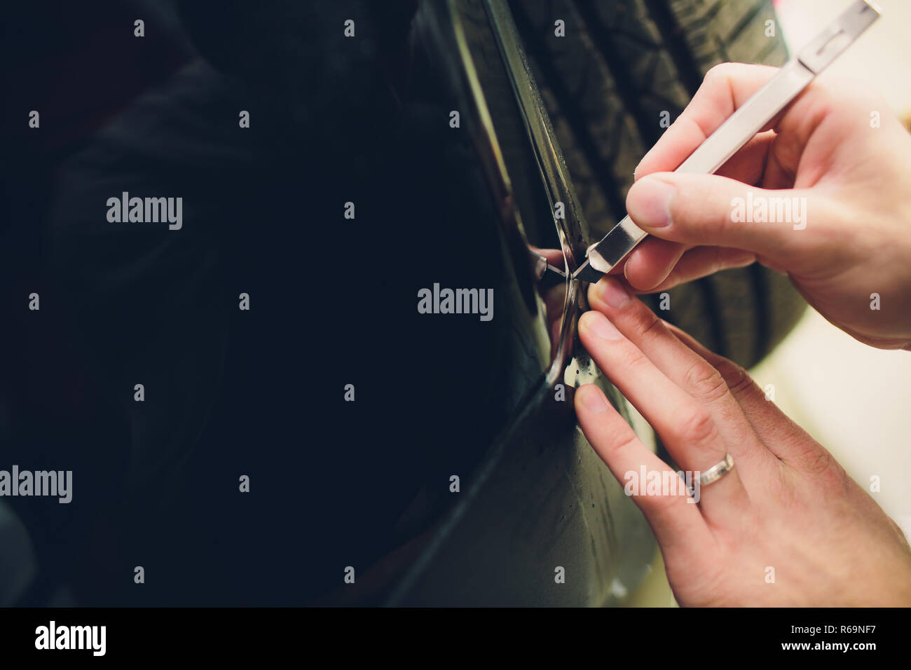 Worker hands installs car paint protection film Stock Photo - Alamy