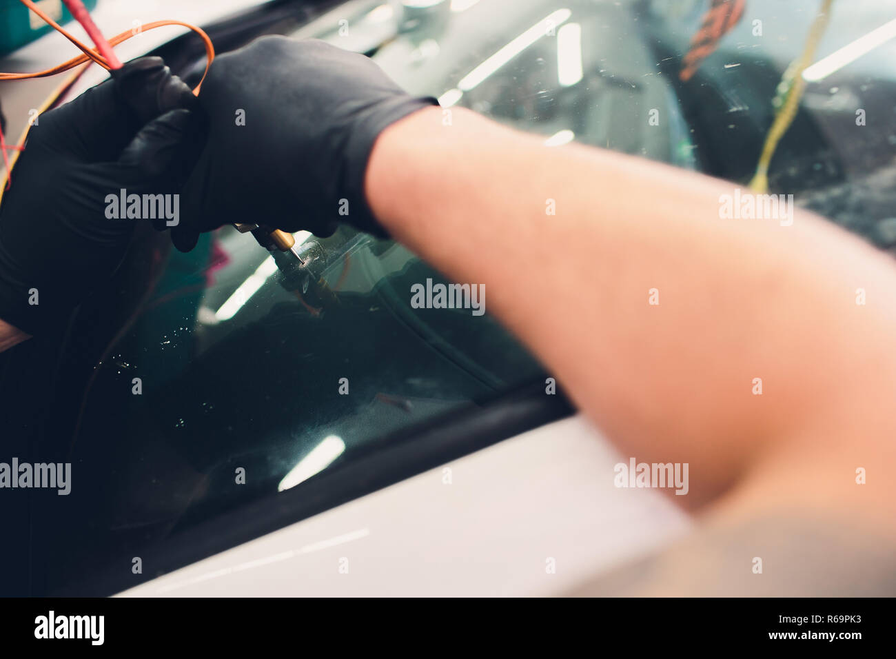 Using tools repairing to fix crack windshield Stock Photo - Alamy