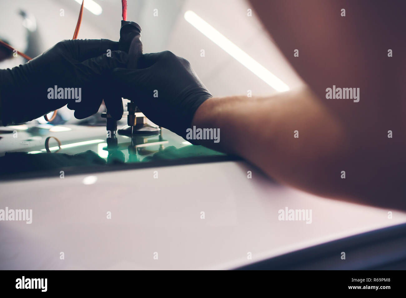 Using tools repairing to fix crack windshield Stock Photo - Alamy