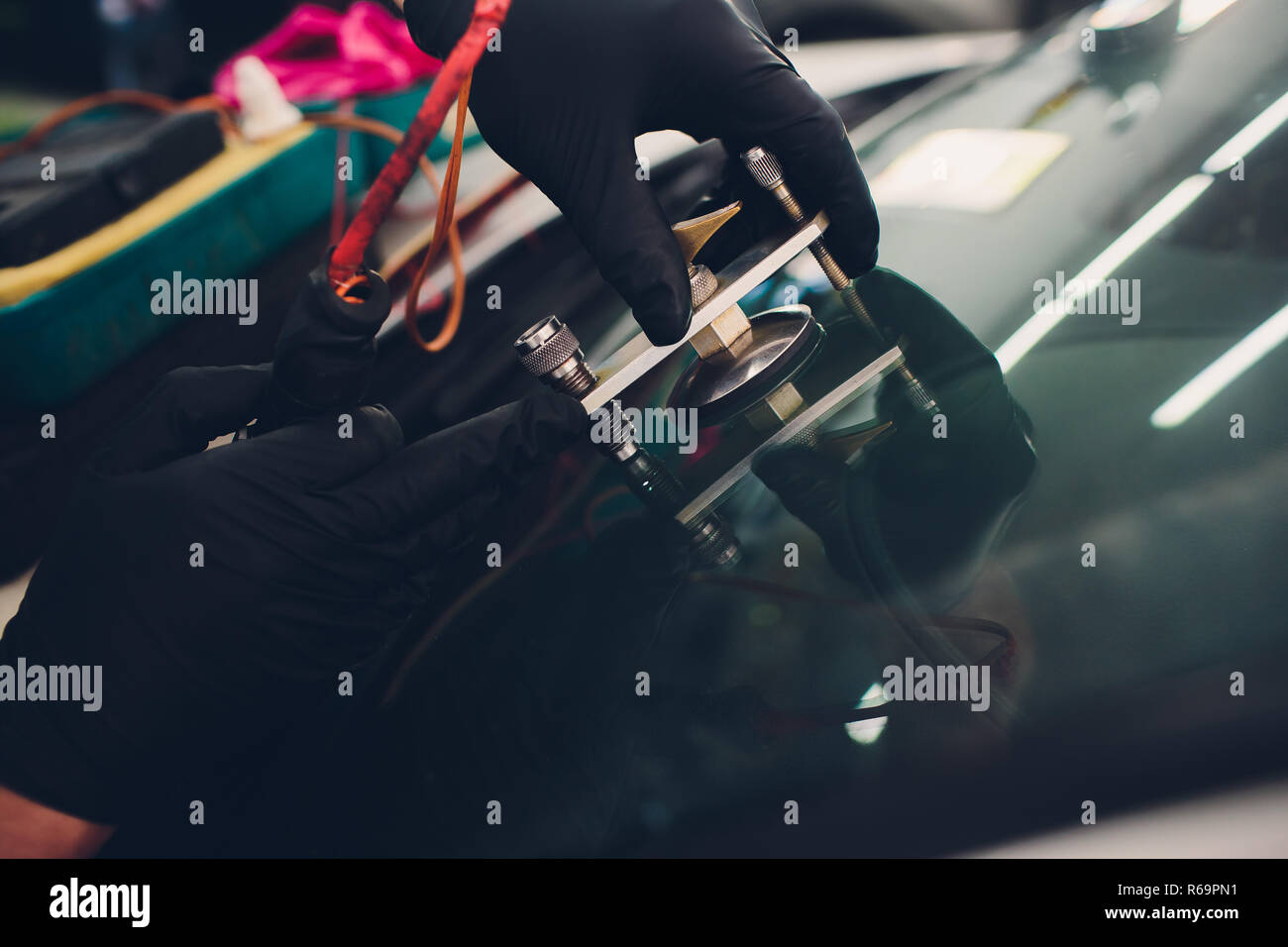 Using tools repairing to fix crack windshield Stock Photo - Alamy