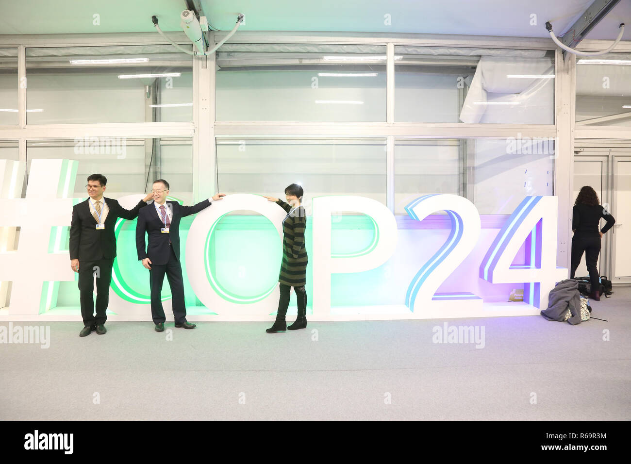 Guests posing to photograph on the COP 24 logo in the background ...
