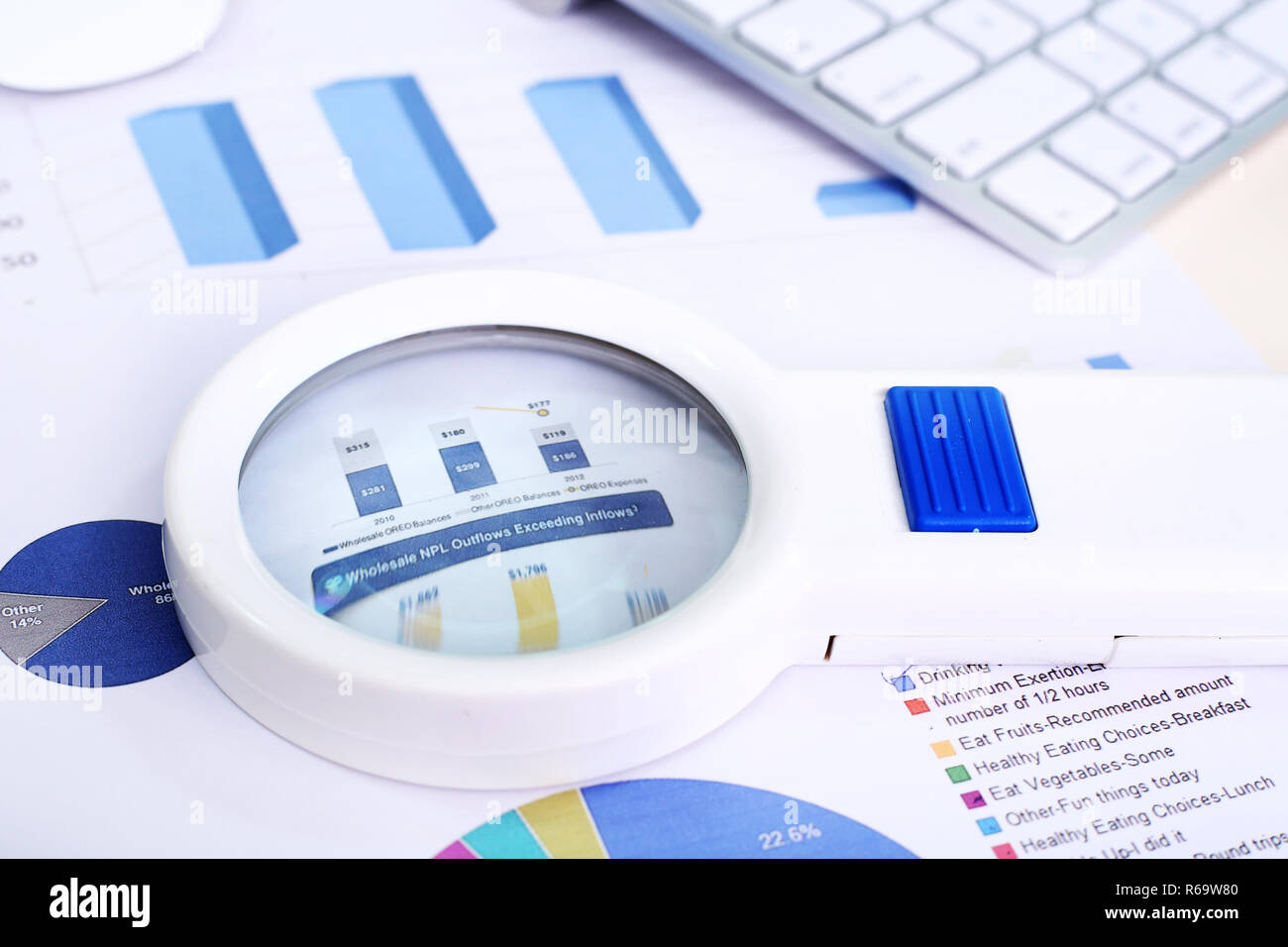 Magnifying glass, graph paper and keyboard on the table Stock Photo - Alamy