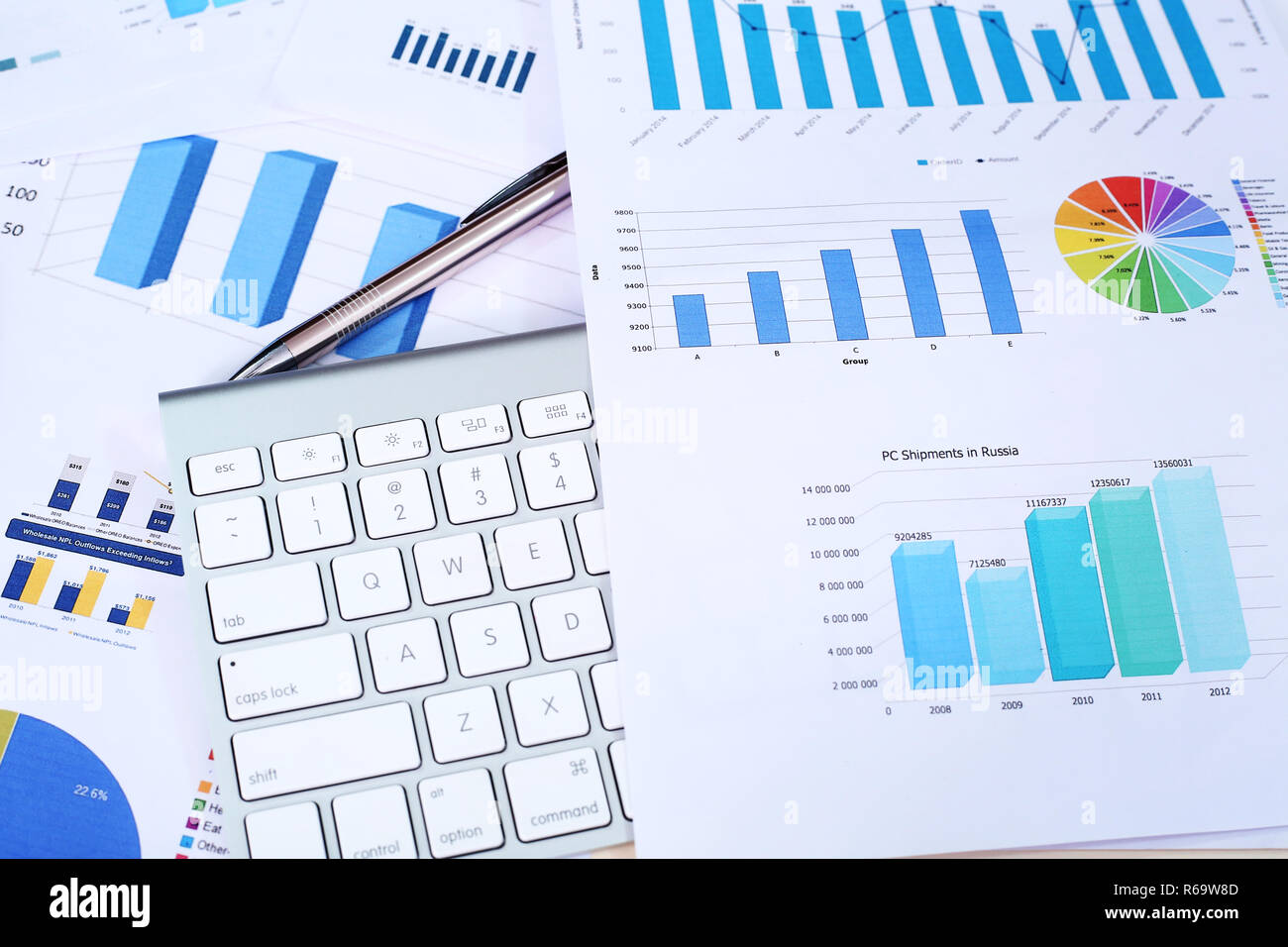 Photo of bar graph paper, keyboard and pen Stock Photo - Alamy