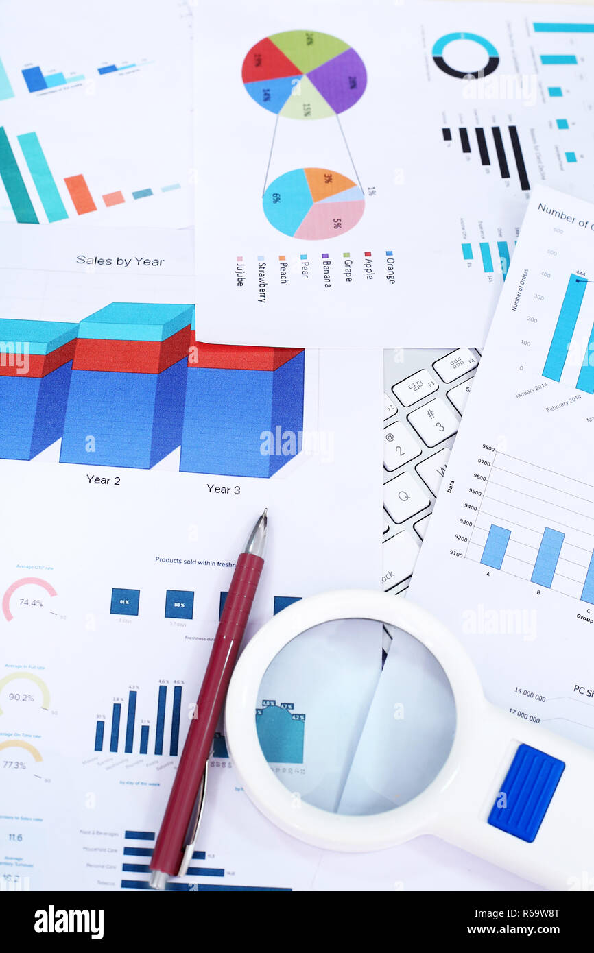 Picture of bar graph paper, pen and magnifying glass Stock Photo - Alamy