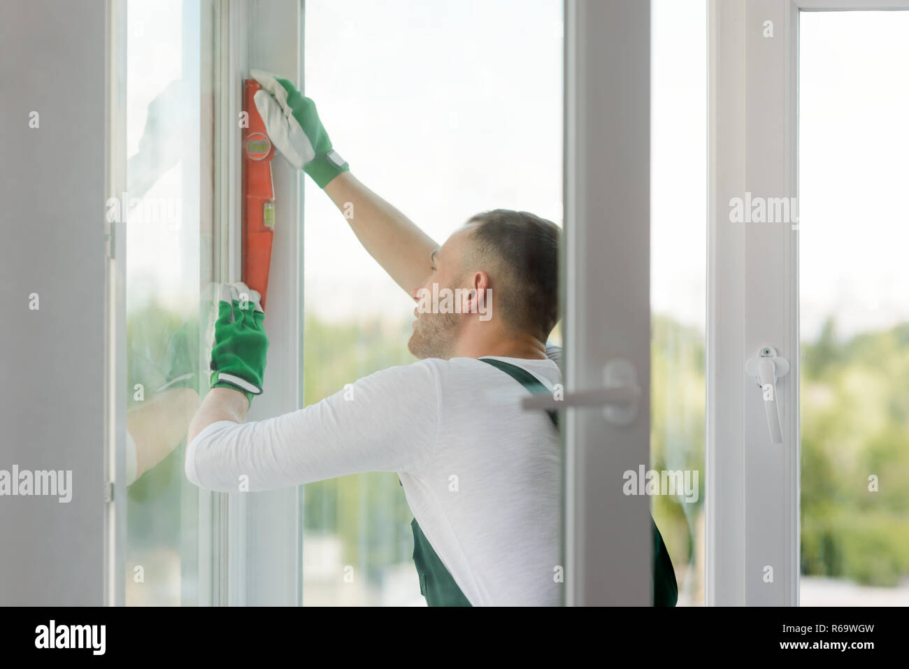 Foreman checking accuracy with level Stock Photo - Alamy