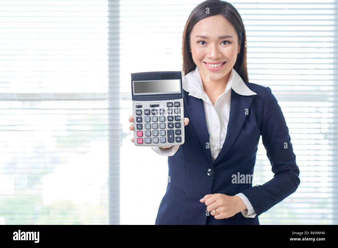 Asian woman female using calculator hi-res stock photography and images ...