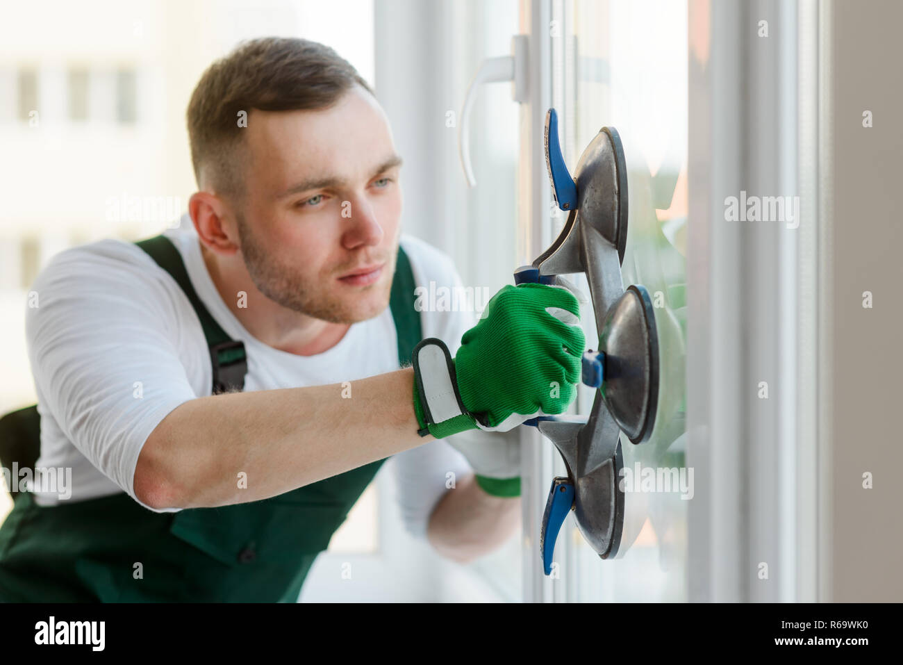 Man is installing a window Stock Photo - Alamy