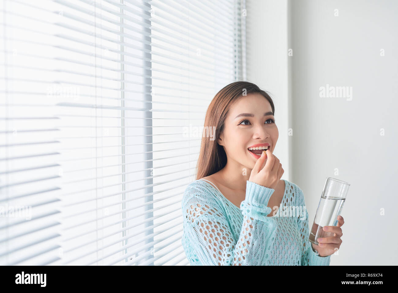 Omega 3. Fat fish. Beautiful girl takes fish oil. Woman takes omega 3 ...