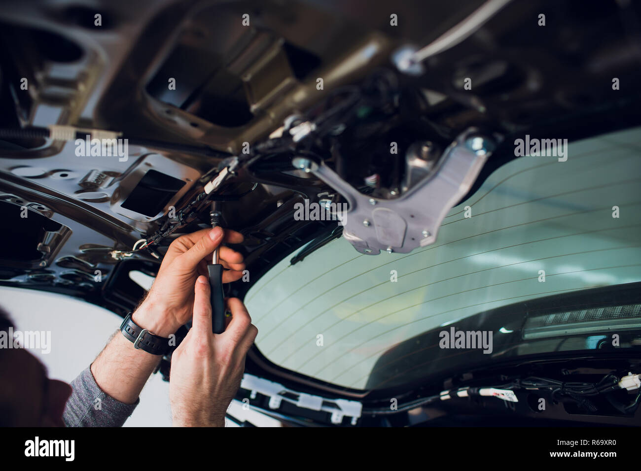 Mechanic installing car central door lock motor Stock Photo - Alamy