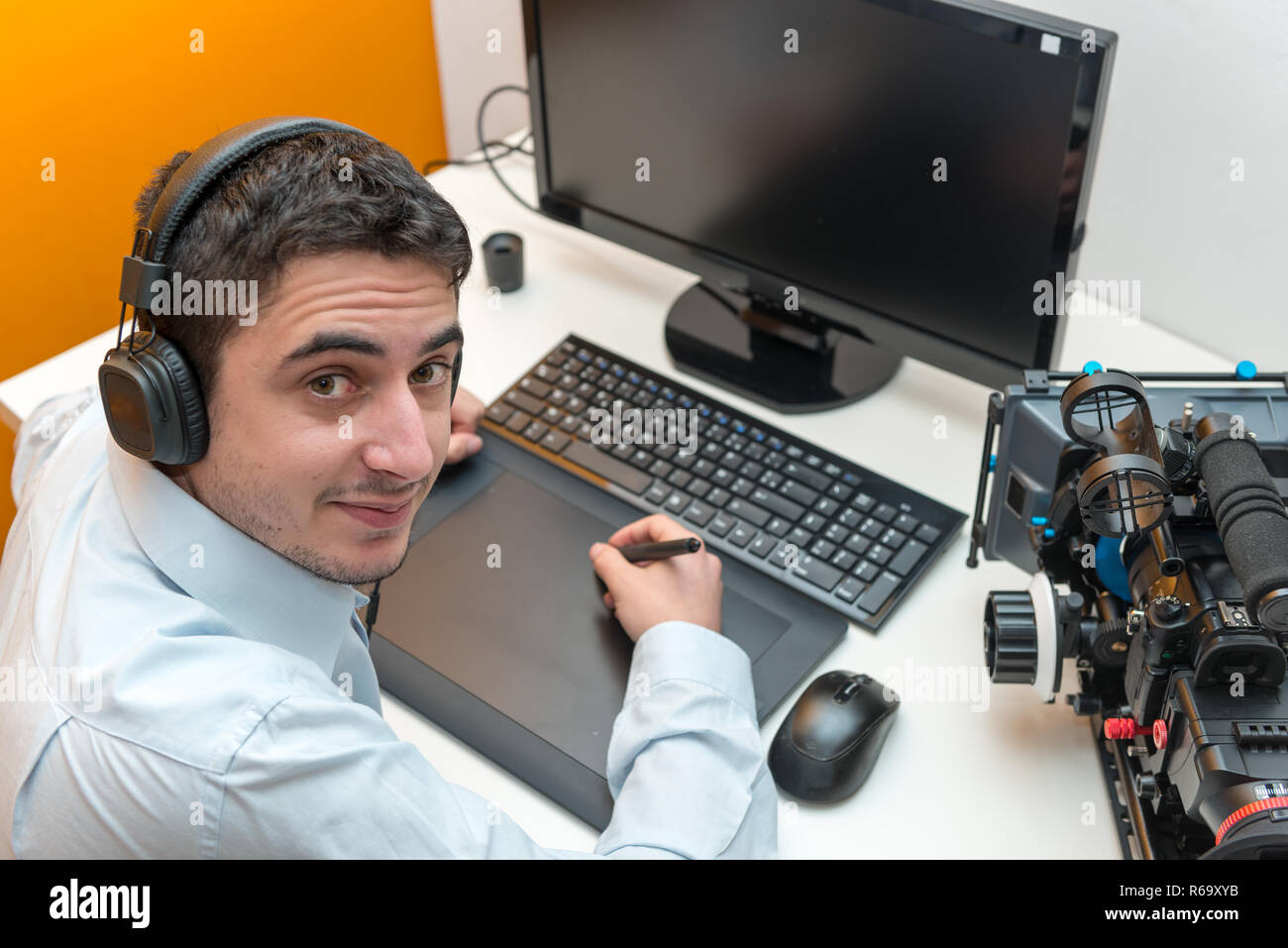 young man designer using graphics tablet for video editing Stock Photo ...