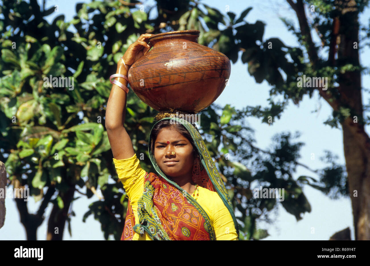 Woman carrying pot water on hi-res stock photography and images - Alamy