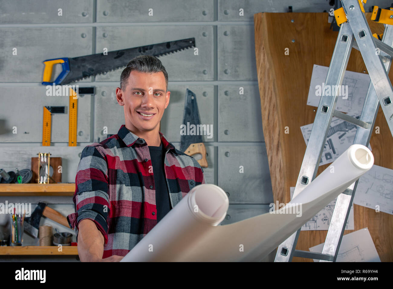 A carpenter works. Carpenter studying drawing project. Against the ...