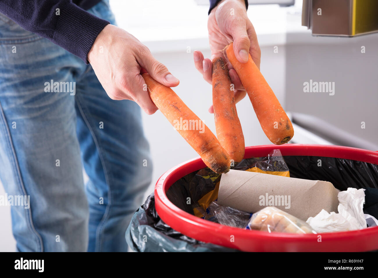 Person Throwing Carrot In Dustbin Stock Photo - Alamy