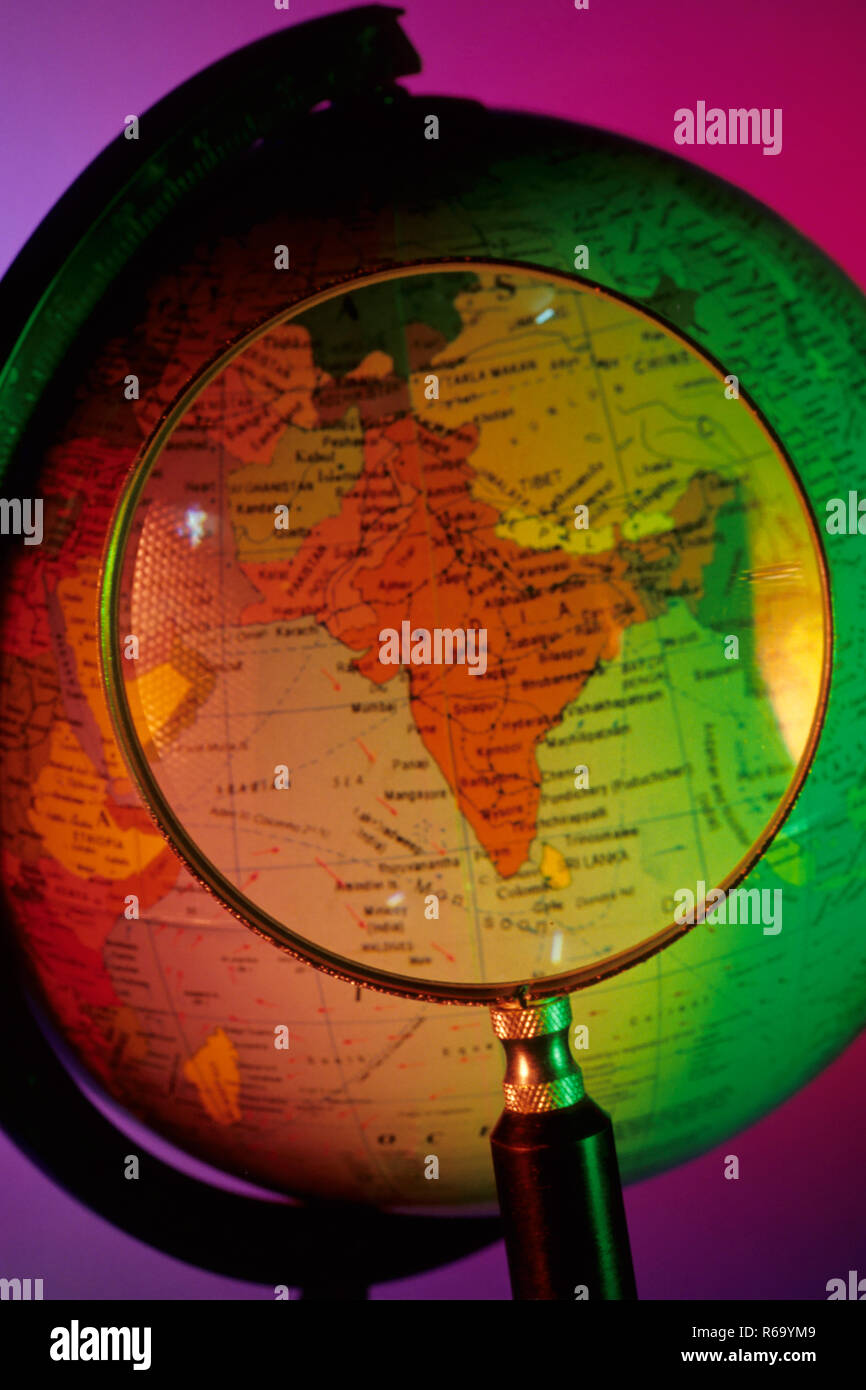 Magnifying glass showing India on globe Stock Photo - Alamy