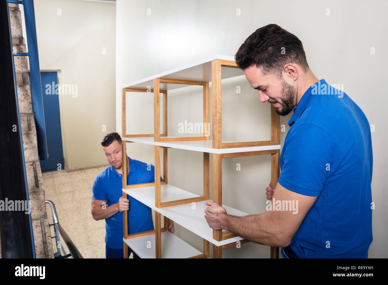 Two Men Carrying Shelf Stock Photo - Alamy