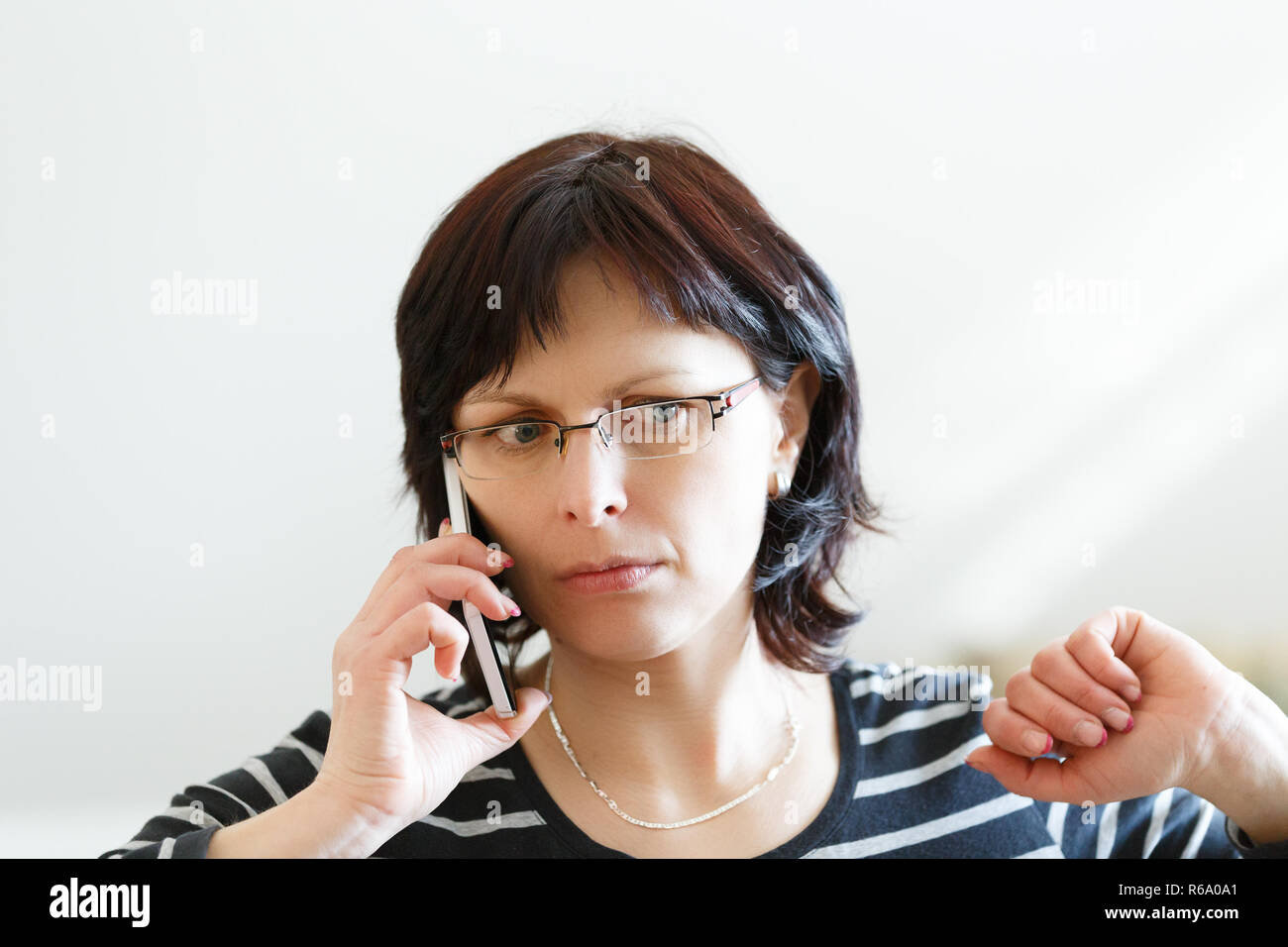 tired middle-aged woman call by phone Stock Photo - Alamy