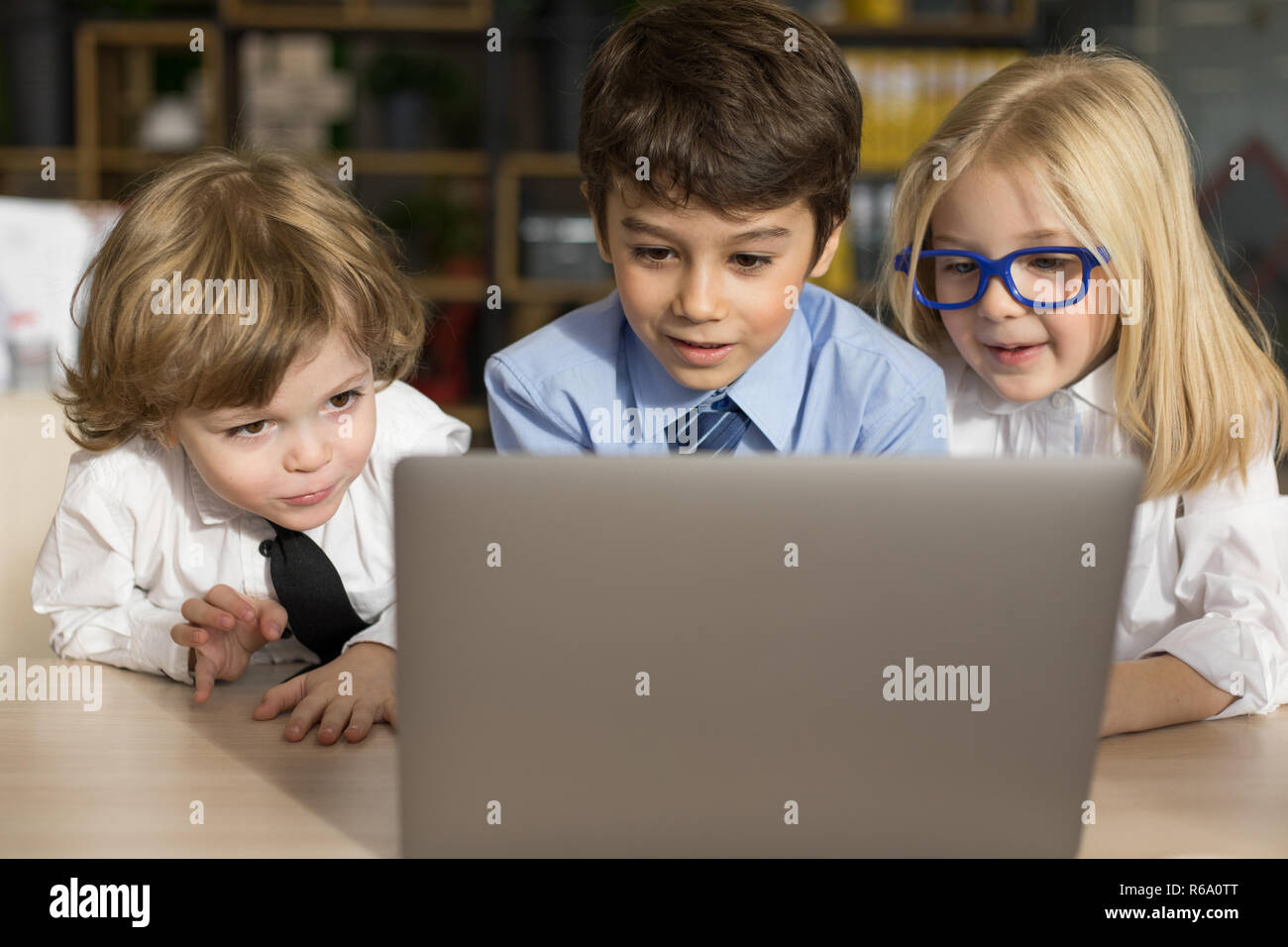 Little children businessmen work in the office and use a laptop Stock ...