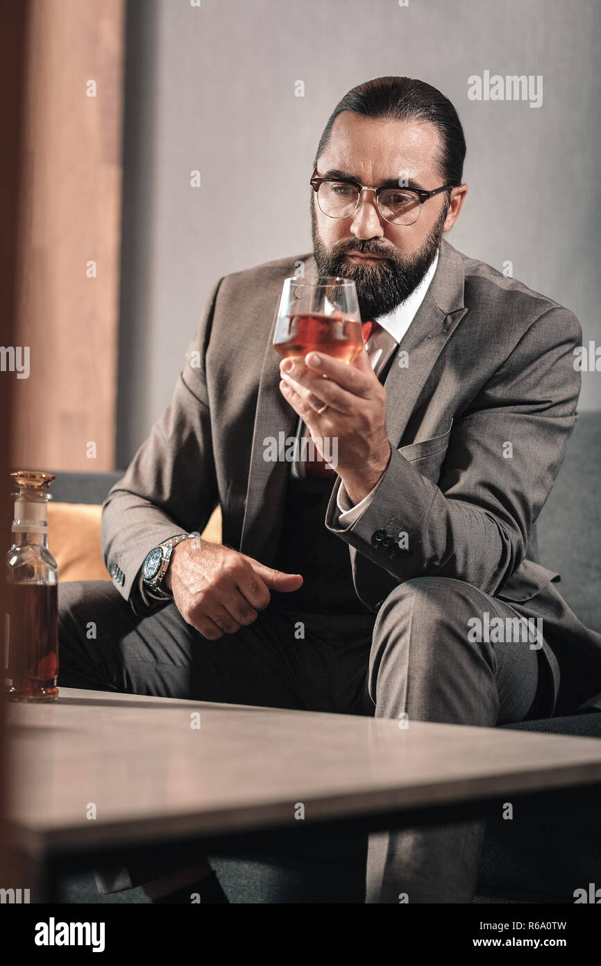 Bearded dark-haired man feeling awful after leaving his family Stock ...