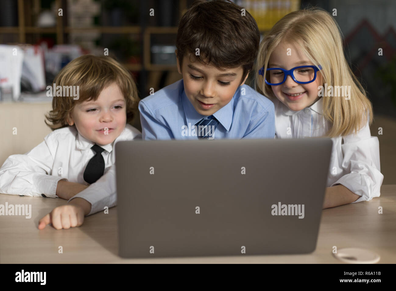 Little children businessmen work in the office and use a laptop Stock ...