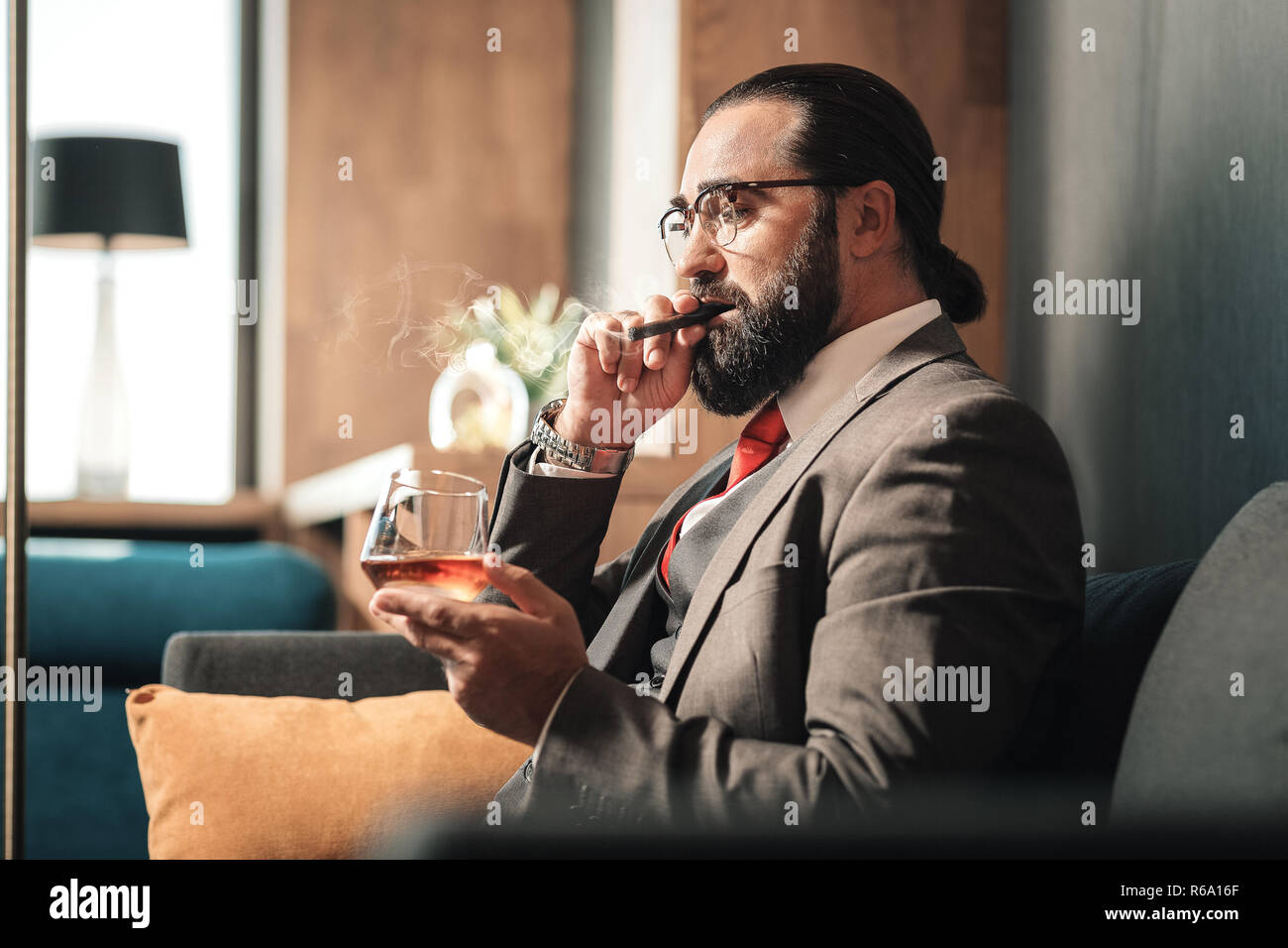 Businessman smoking cigar hi-res stock photography and images - Alamy