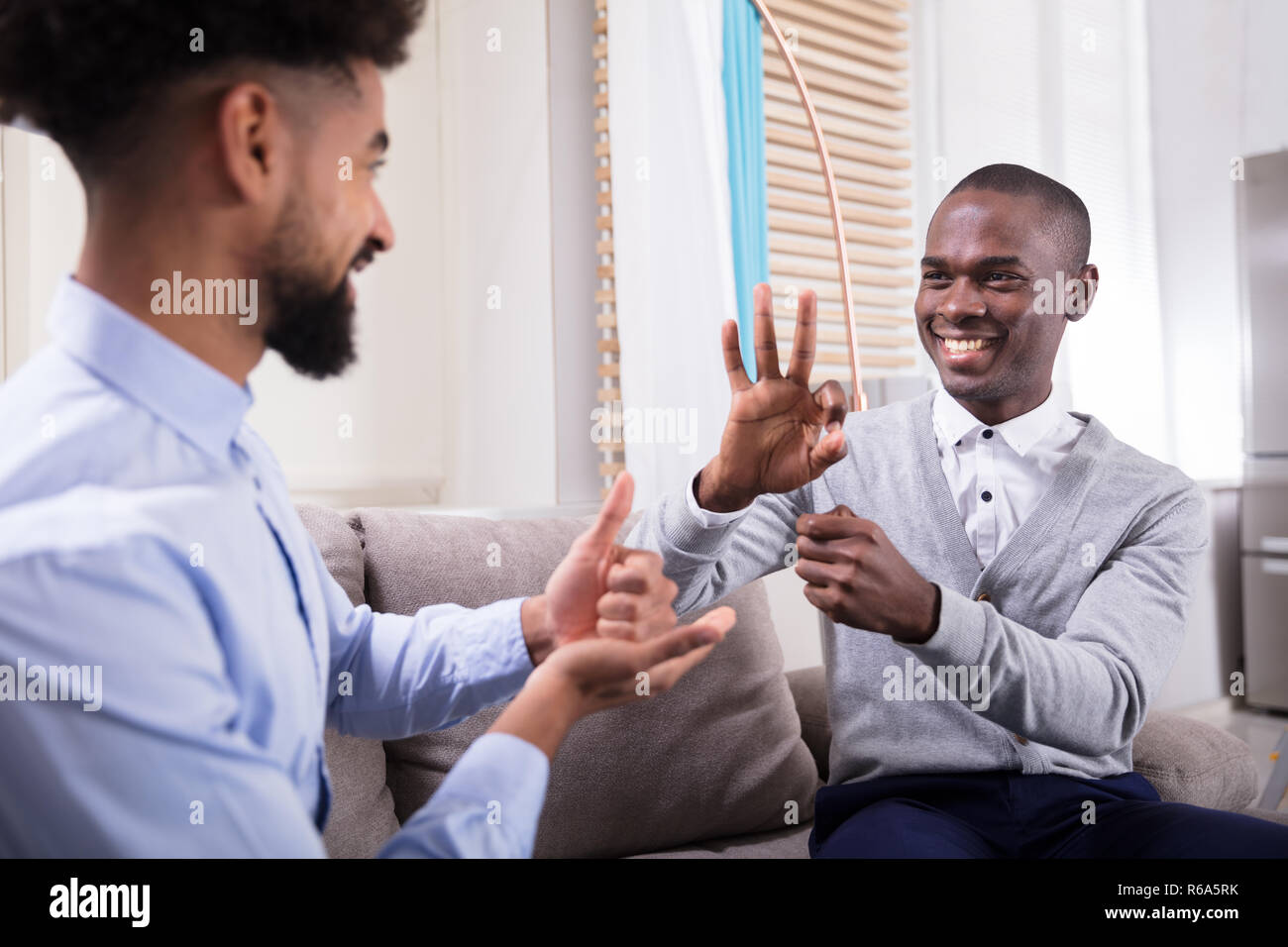 Two Happy Men Making Sign Language Stock Photo - Alamy