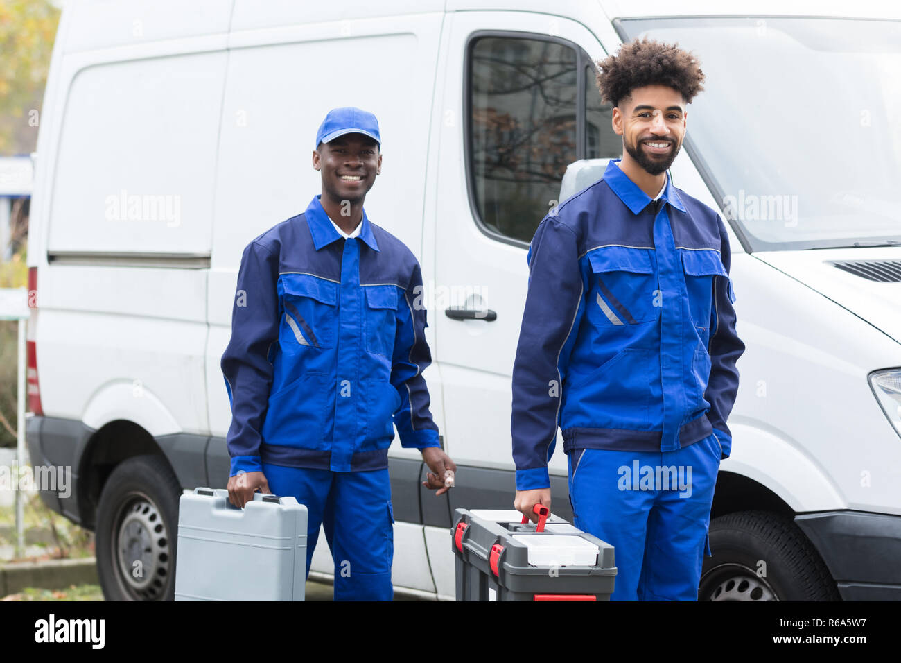 Portrait Of Two Young Manual Worker With Their Tool Boxes Stock Photo ...