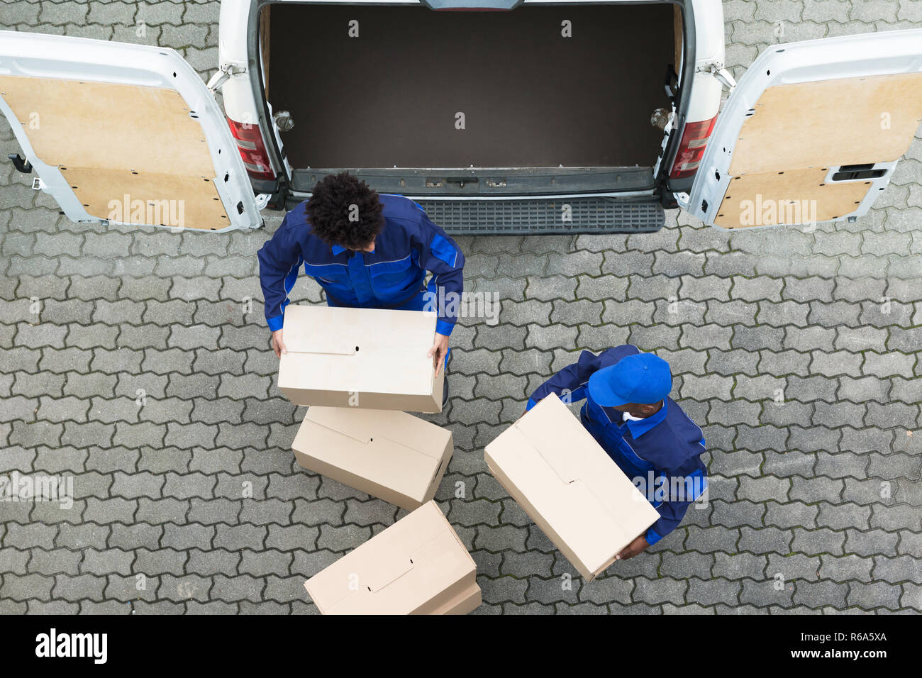 Delivery man putting carton boxes hi-res stock photography and images ...
