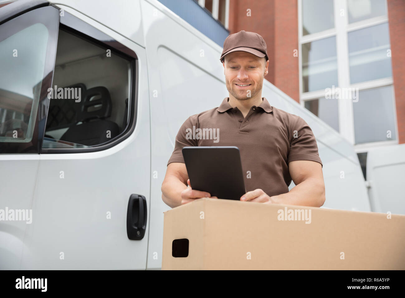 Delivery Man Using Digital Tablet Stock Photo - Alamy