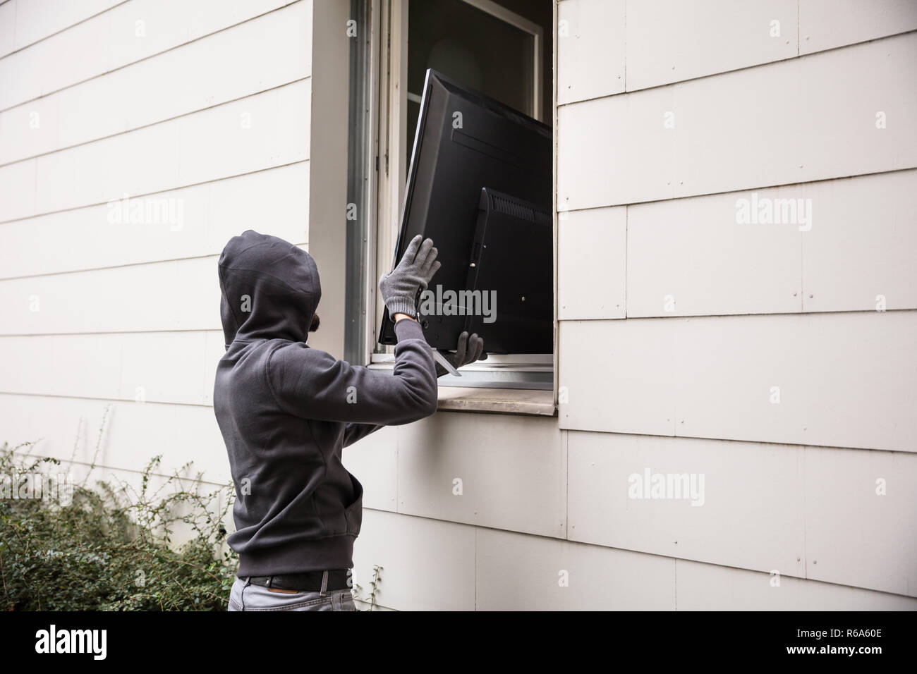 Robbers Stealing Television Through House Window Stock Photo - Alamy