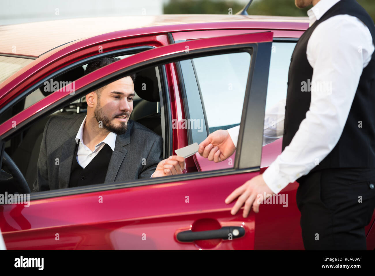 Valet Giving Receipt To Businessperson Sitting Inside Car Stock Photo ...