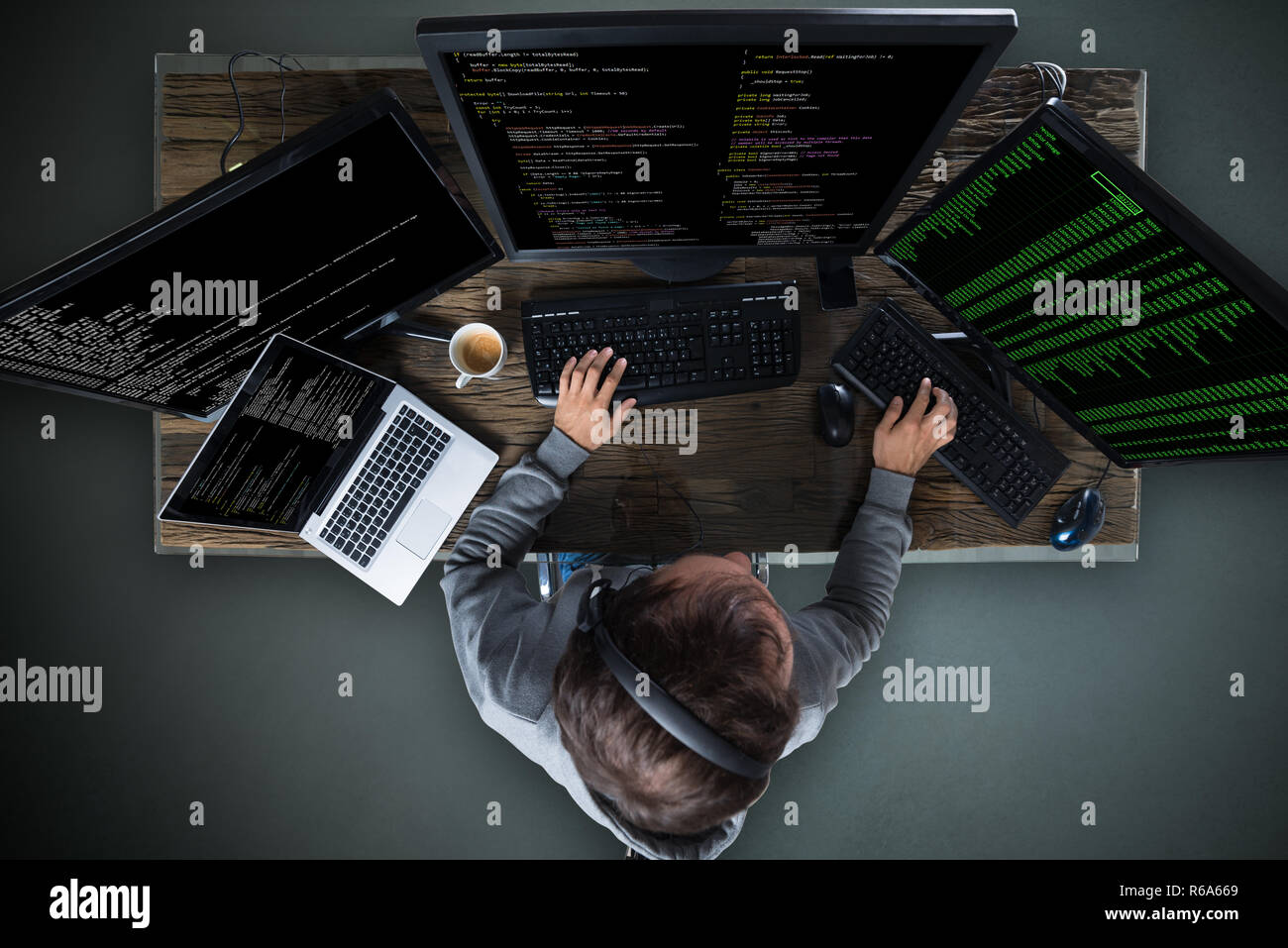 Hacker Hacking Multiple Computers On Desk Stock Photo - Alamy