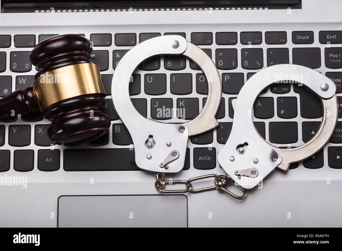 Handcuffs And Gavel On Laptop Keyboard Stock Photo - Alamy