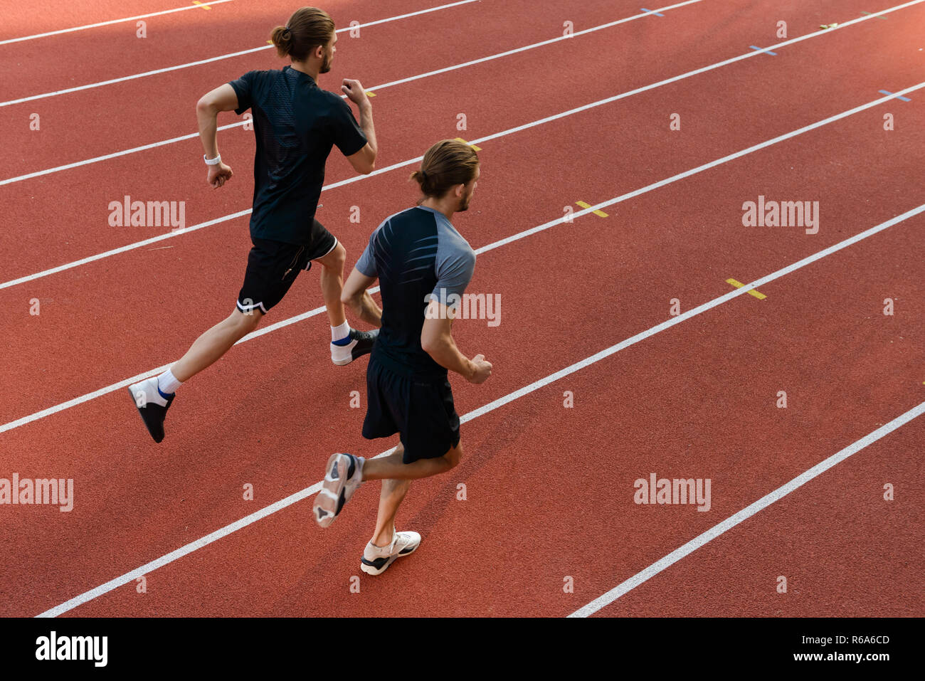 Image of young two twins sportsmen brothers running at the stadium ...