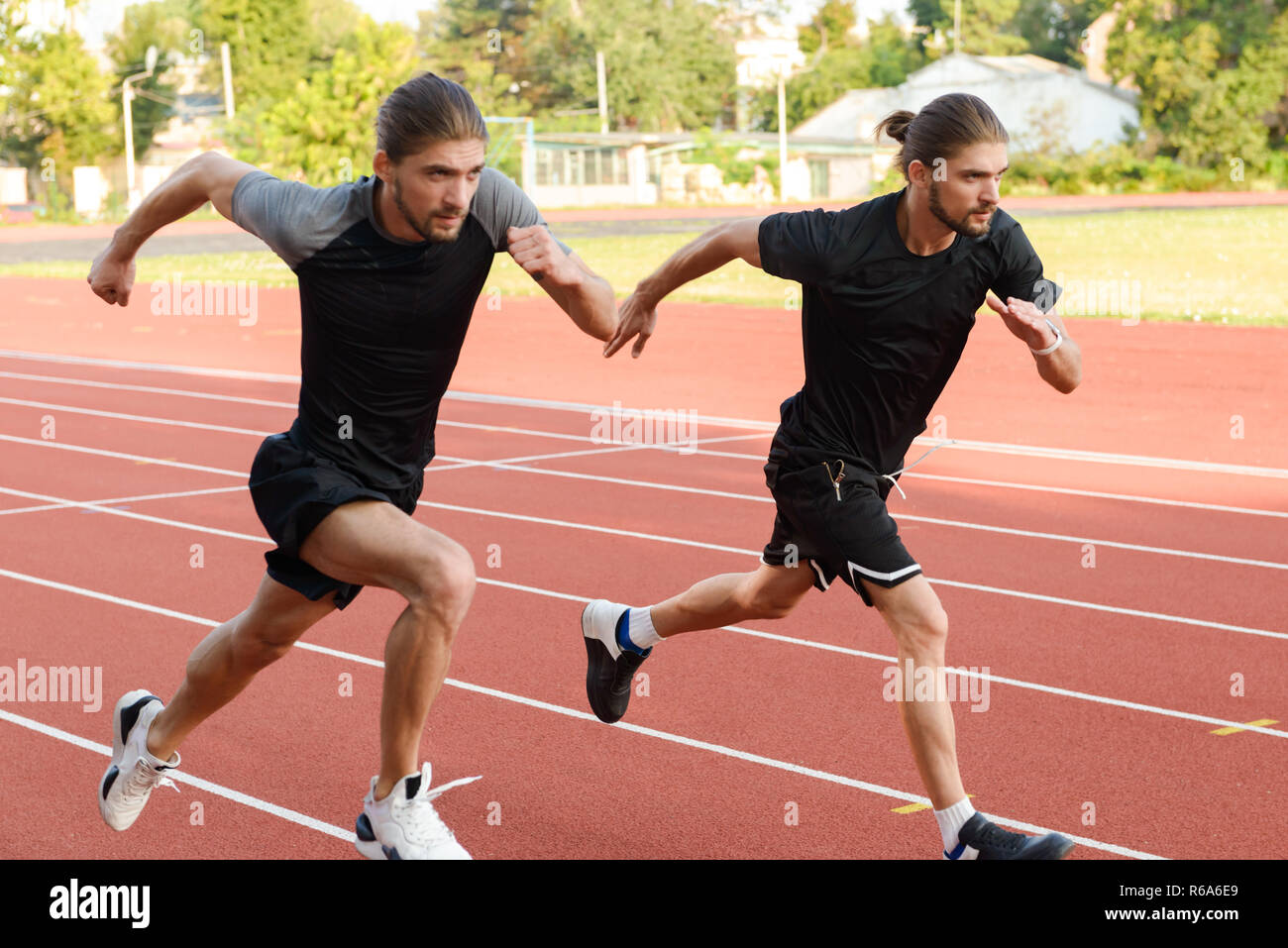 Image of young two twins sportsmen brothers running at the stadium ...