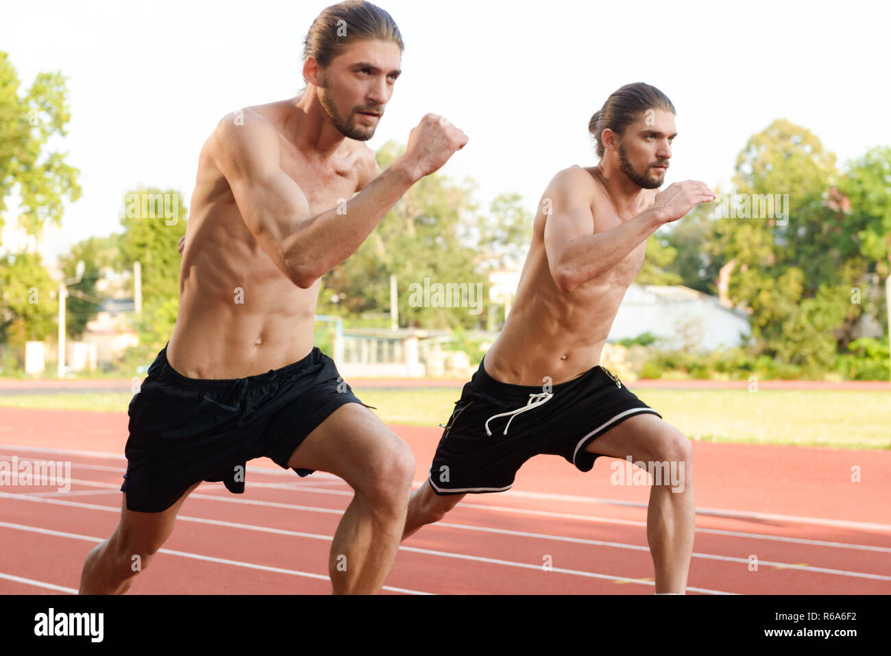 Image of young two twins sportsmen brothers running at the stadium ...