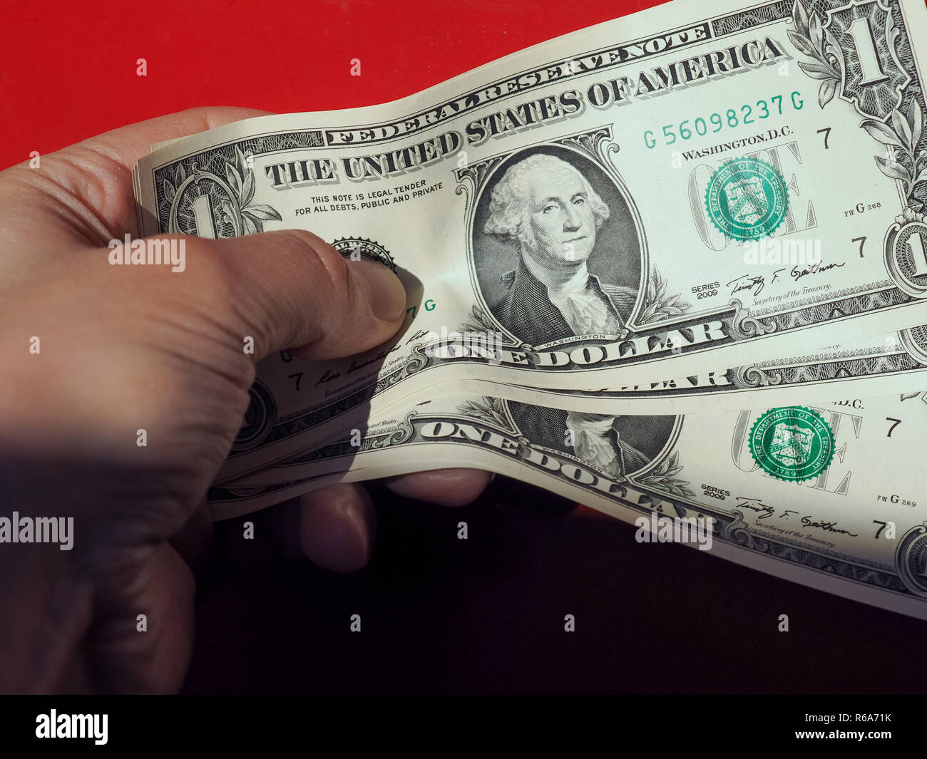 Hand giving Dollar notes, United States Stock Photo - Alamy