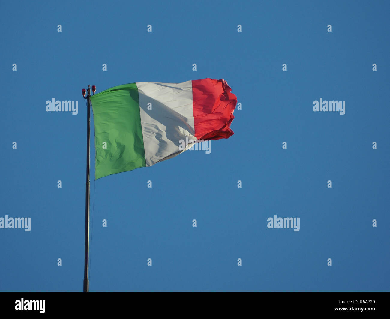 Italian Flag of Italy over blue sky Stock Photo - Alamy