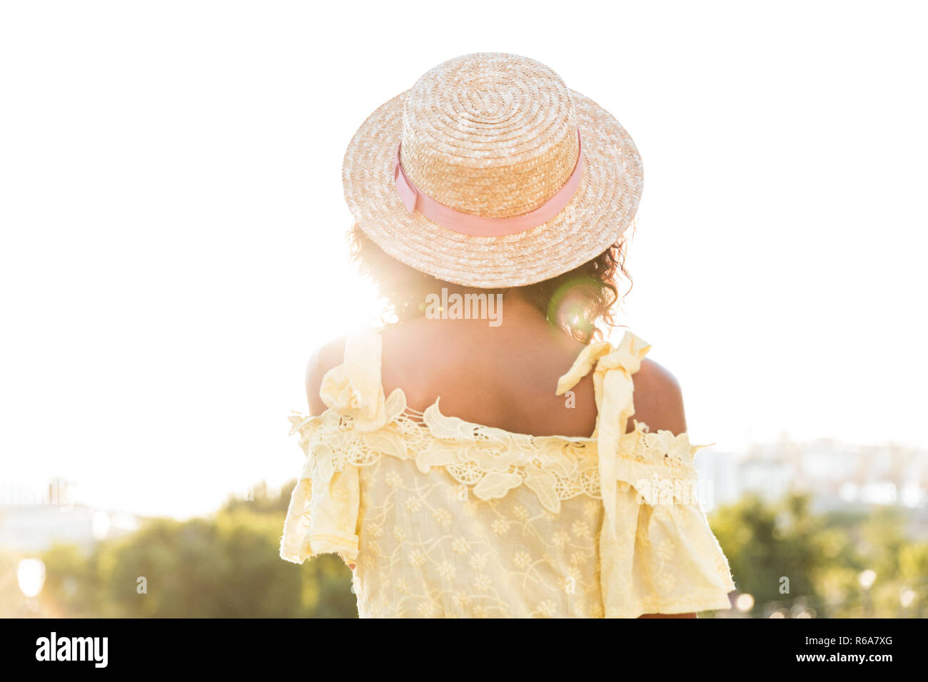 Back view photo of african young woman walking outdoors with beautiful ...