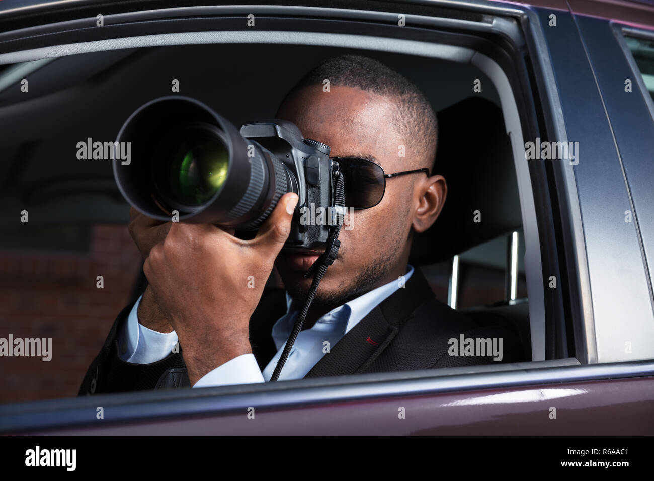 Detective Sitting Inside Car Photographing Stock Photo - Alamy