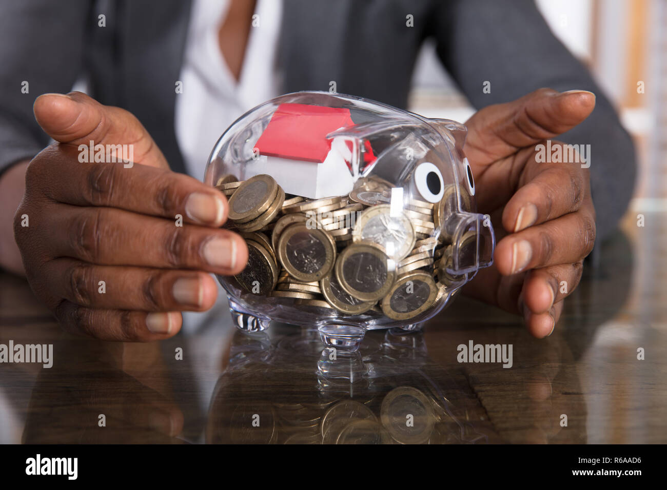 Human Hand Protection Piggy Bank With House Model And Coins Stock Photo ...
