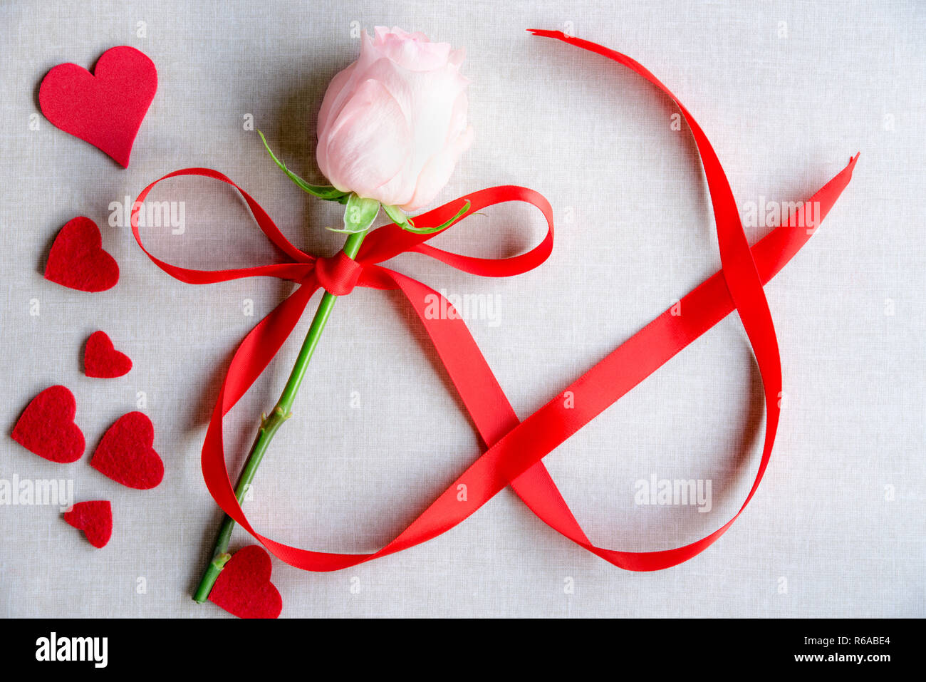 Hearts and a rose with ribbon in shape of infinity Stock Photo - Alamy