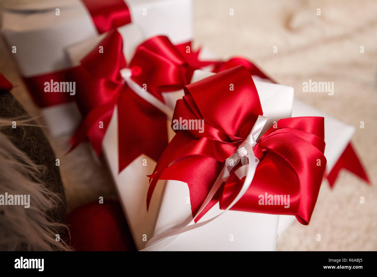 Lovely presents under Christmas tree, gift boxes on white, fluffy, cozy ...