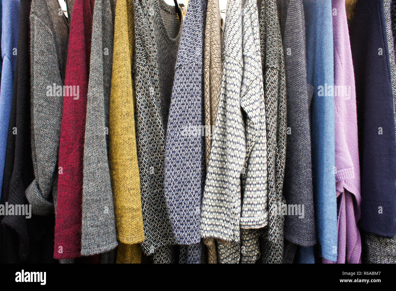 A selection of colourful ladies' tops hanging Stock Photo - Alamy