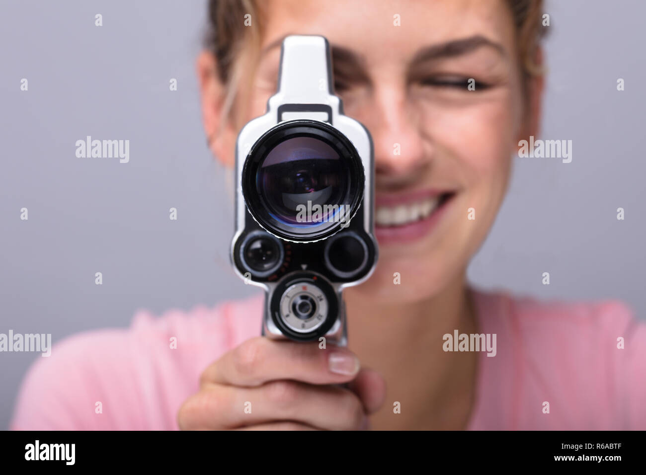 Woman Looking Through Lens Of Retro Camera Stock Photo - Alamy