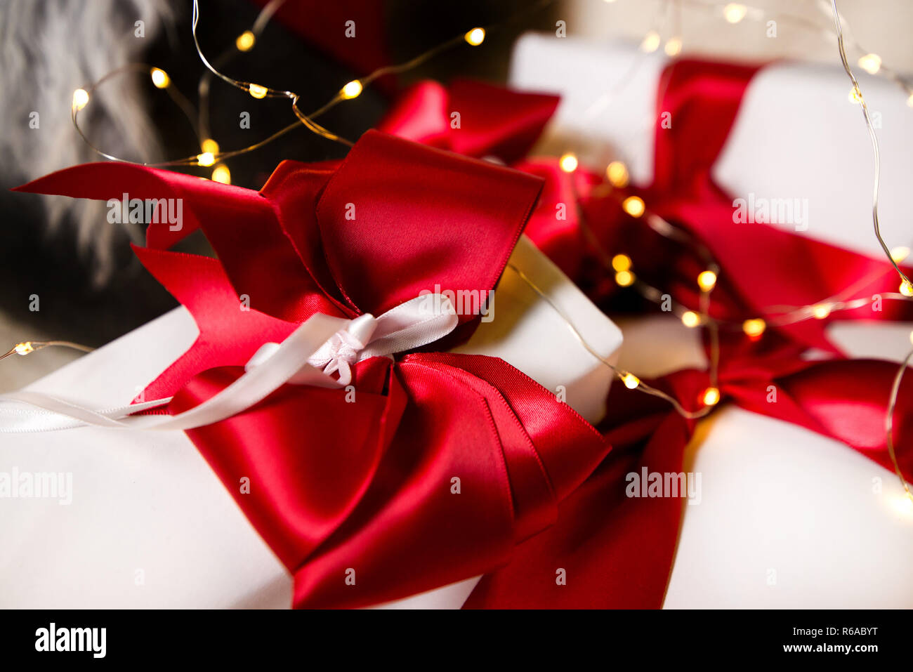 Lovely presents under Christmas tree, gift boxes on white, fluffy, cozy ...