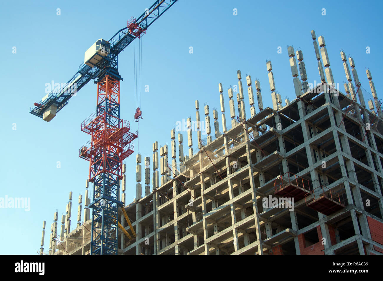 Construction crane in the process of building a new residential ...